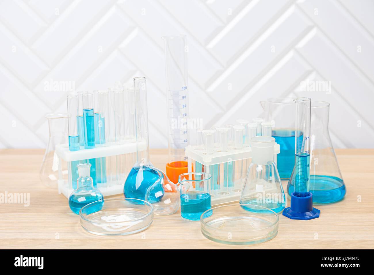 Laboratory glassware with test tubes. flasks, dropper, petri dishes ...