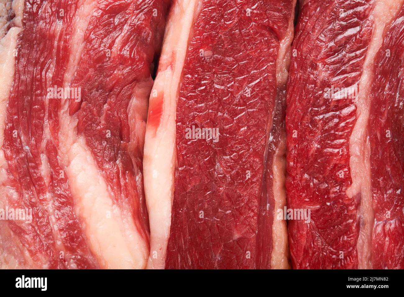 Texture or background steak beef. Raw steak New York with rosemary and ...