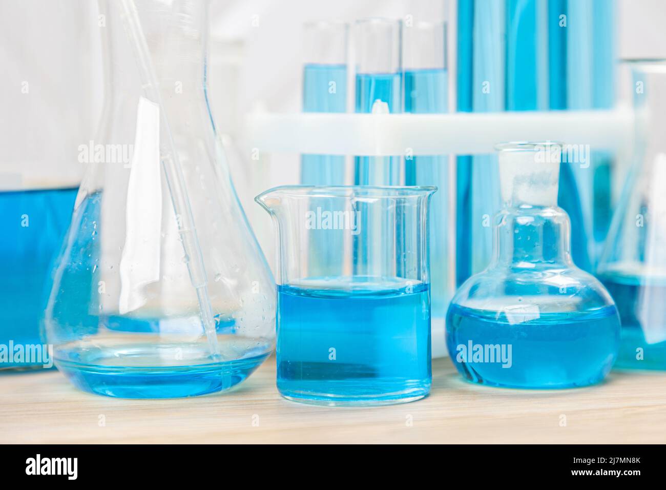 Laboratory glassware with blue liquid in a test tube. scientific ...