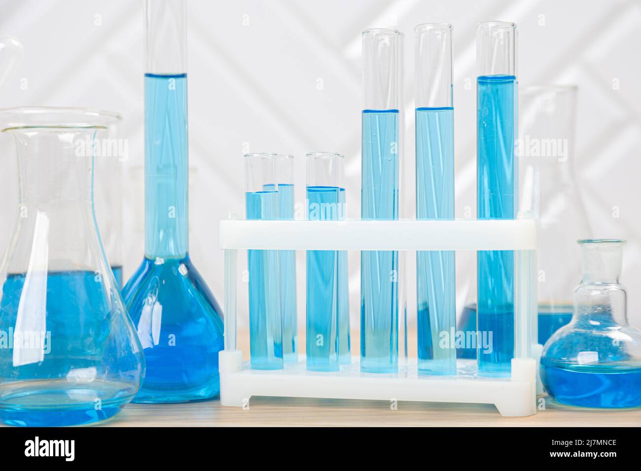 Laboratory glassware with blue liquid in a test tube. scientific ...