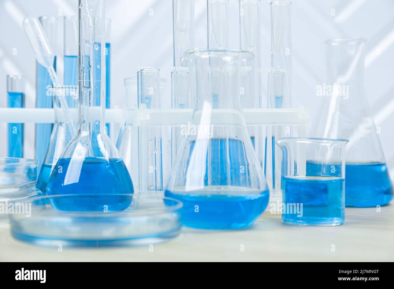 Laboratory glassware with blue liquid in a test tube. scientific ...