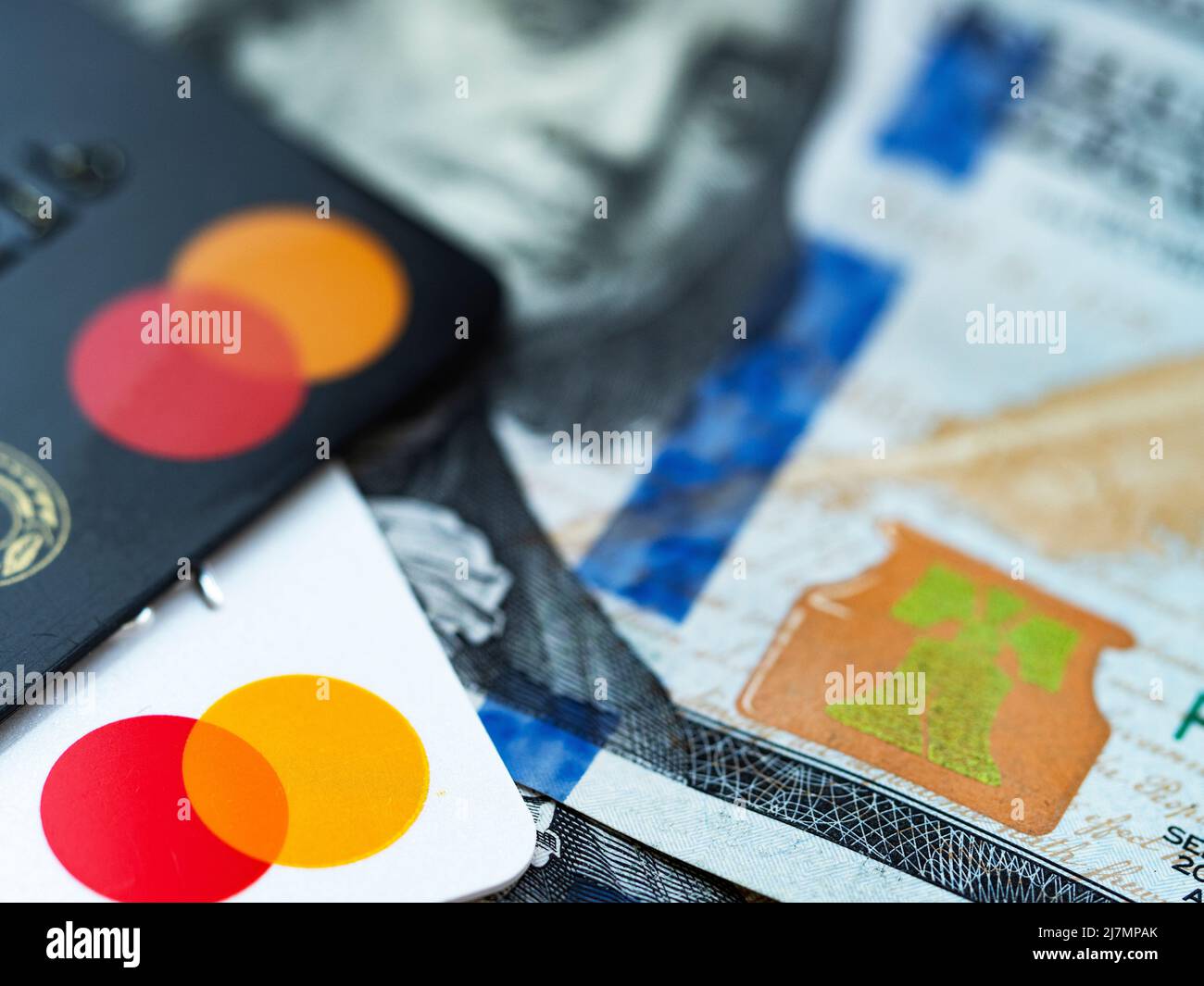In this photo illustration, a Mastercard on the background of 100 ...