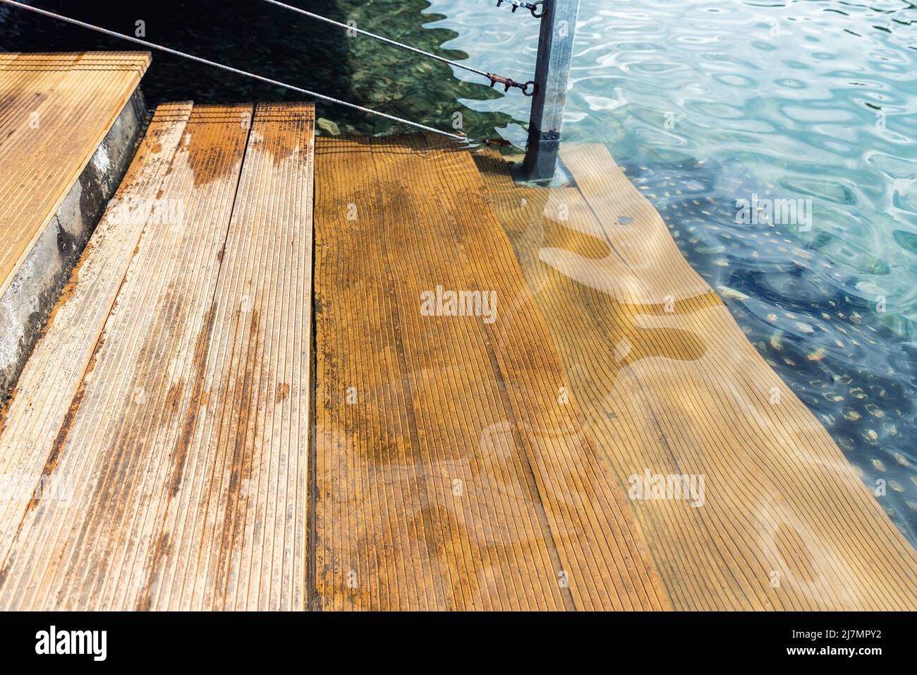 Close-up detail view of natural wooden stair steps of larch ladder into ...