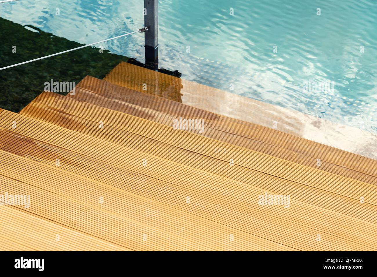 Close-up detail view of natural wooden stair steps of larch ladder into ...