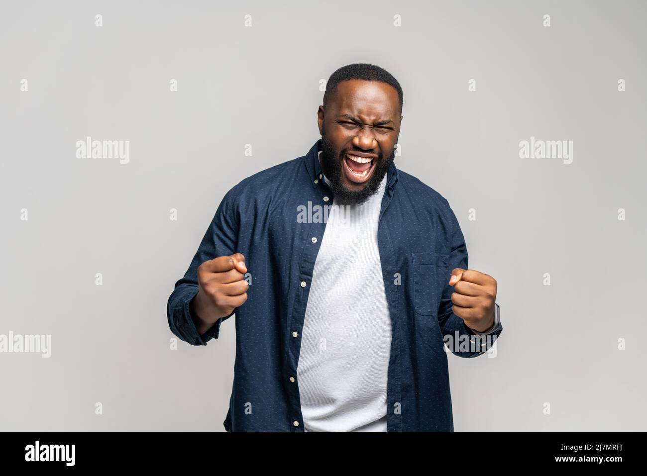 Winner concept. Excited young African American man screaming yes, lucky ...