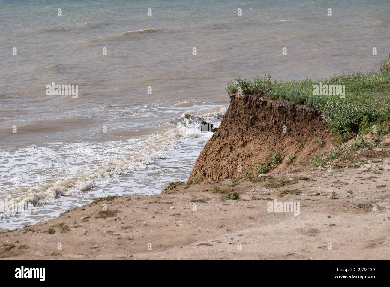 Sea cliffs of boulder clay in front of beaches. Clay Cliffs and Beach with Blue Sky and Water ...