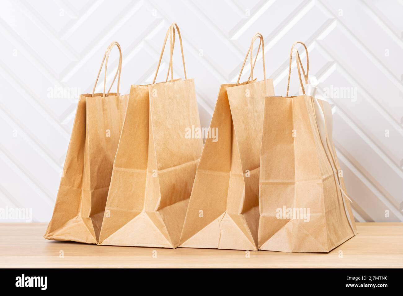 Blank paper carrier bag with handles for shopping, facing front on ...