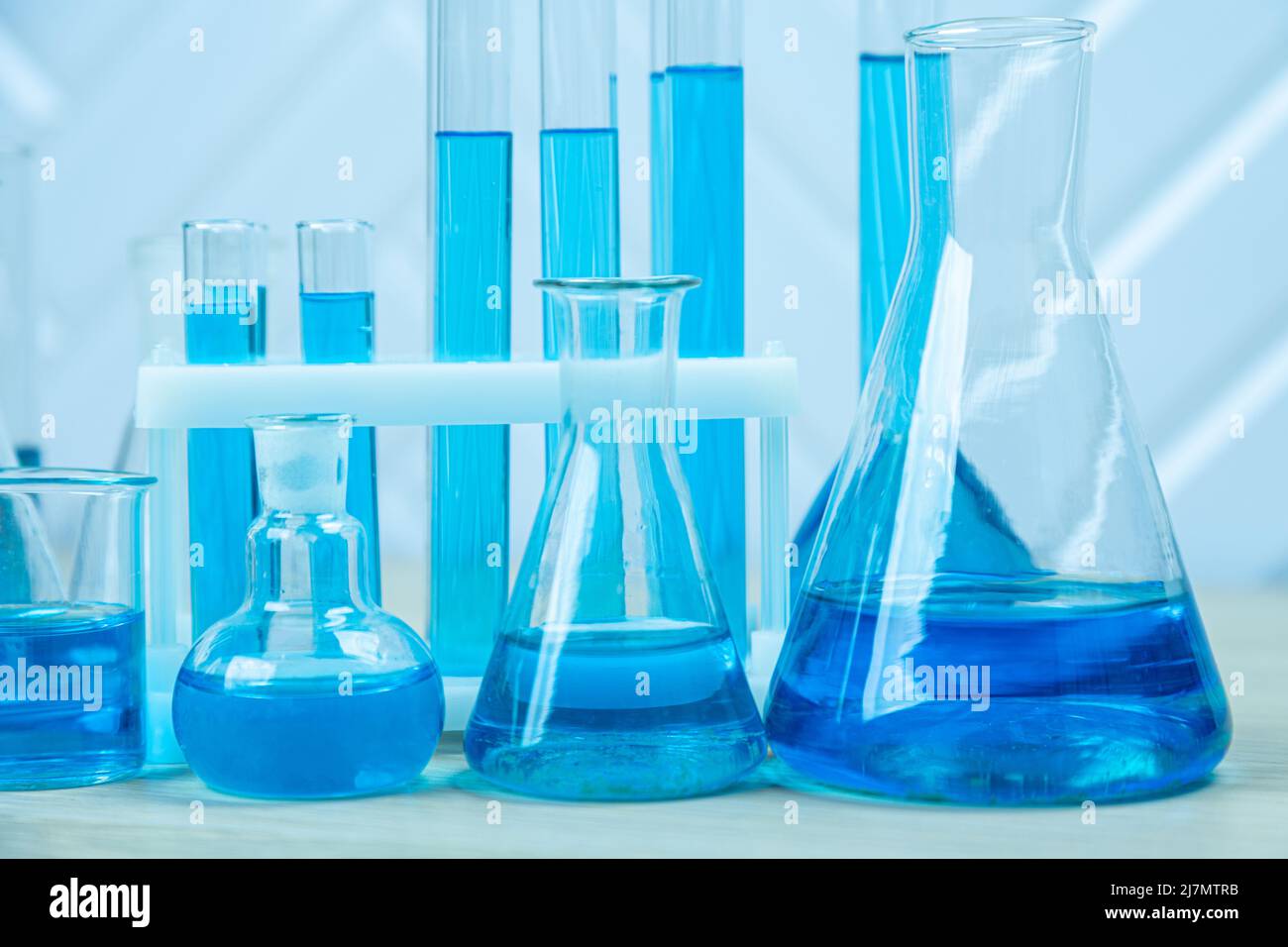 Laboratory glassware with blue liquid in a test tube. scientific ...