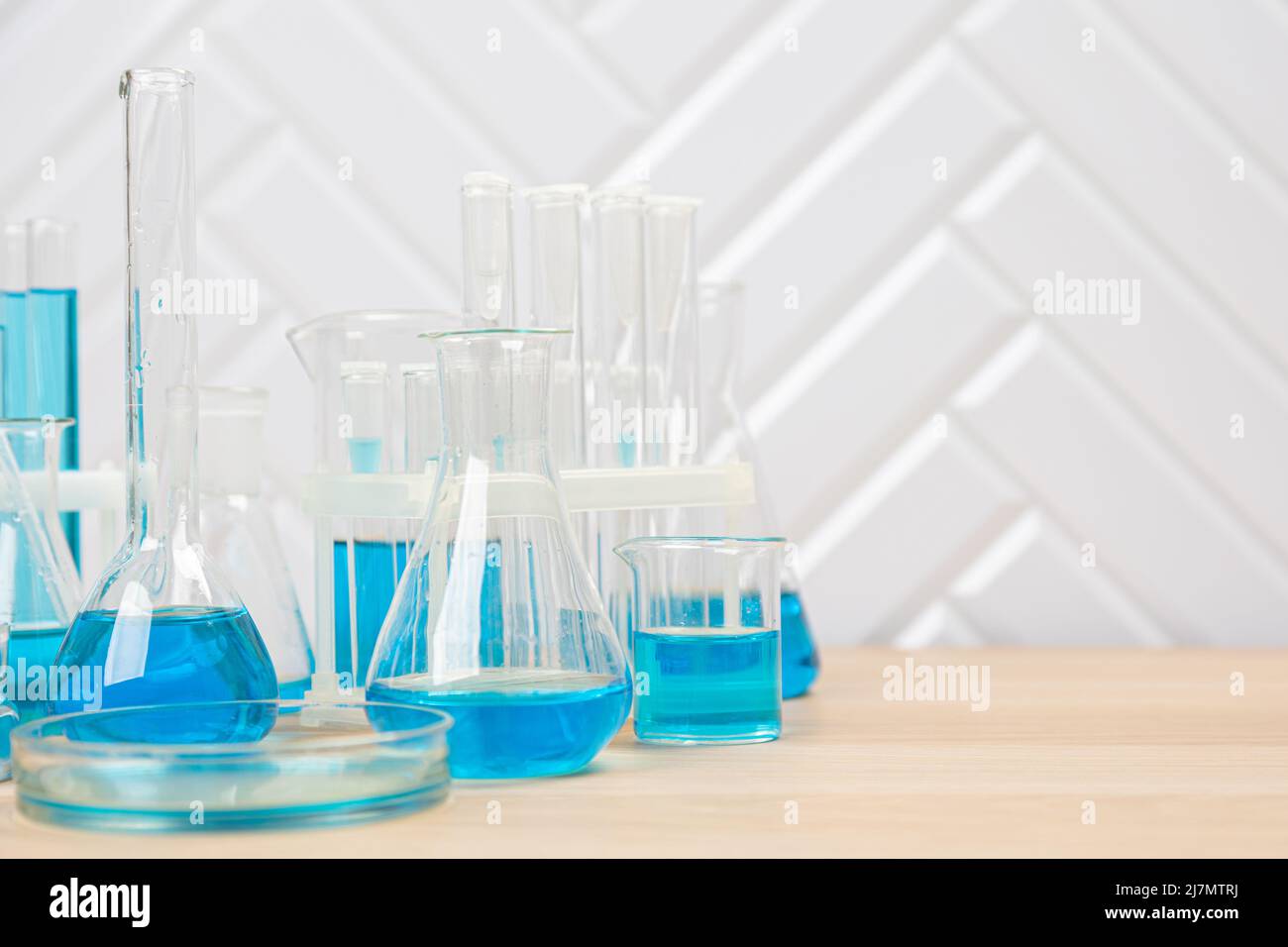 Laboratory glassware with blue liquid in a test tube. scientific ...