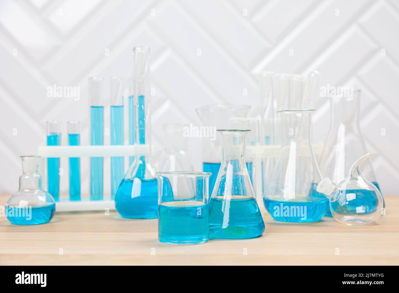 Laboratory glassware with blue liquid in a test tube. scientific ...