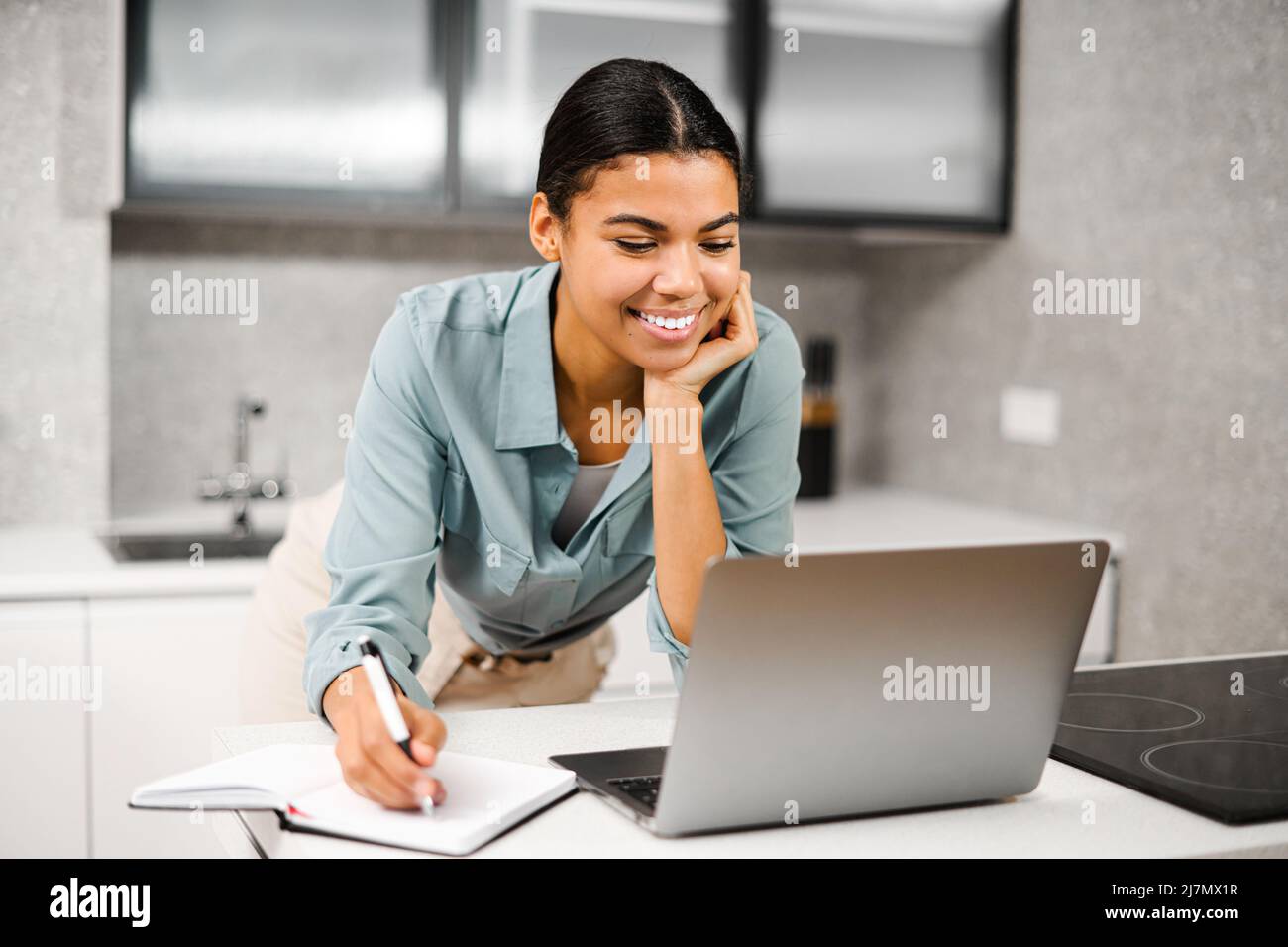 Entrepreneur young woman using laptop in home office. African-american ...