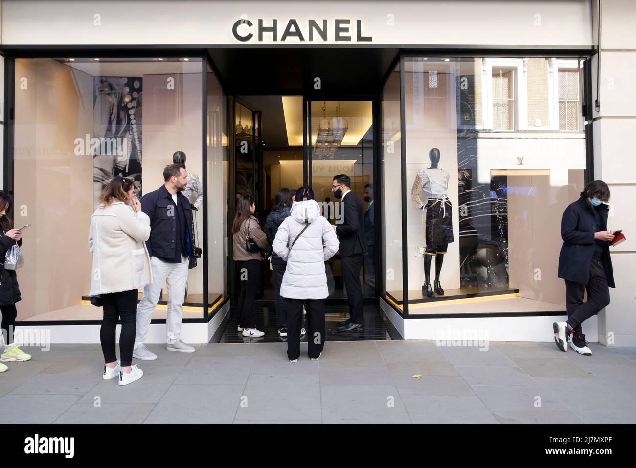 People customers shoppers queue outside Chanel store in New Bond Street ...