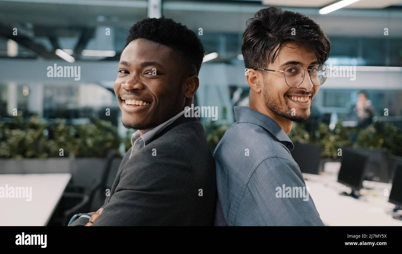 Portrait two multinational male colleagues men African man arab Indian ...