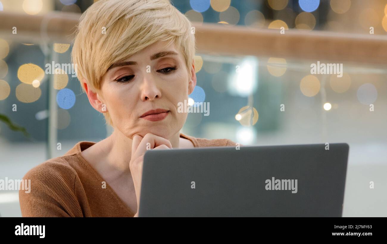 Thoughtful serious doubtful smart middle aged adult 40s woman pensive ...