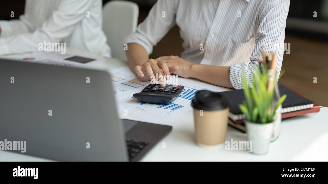 Close up accountant banker or bookkeeper making calculations with ...