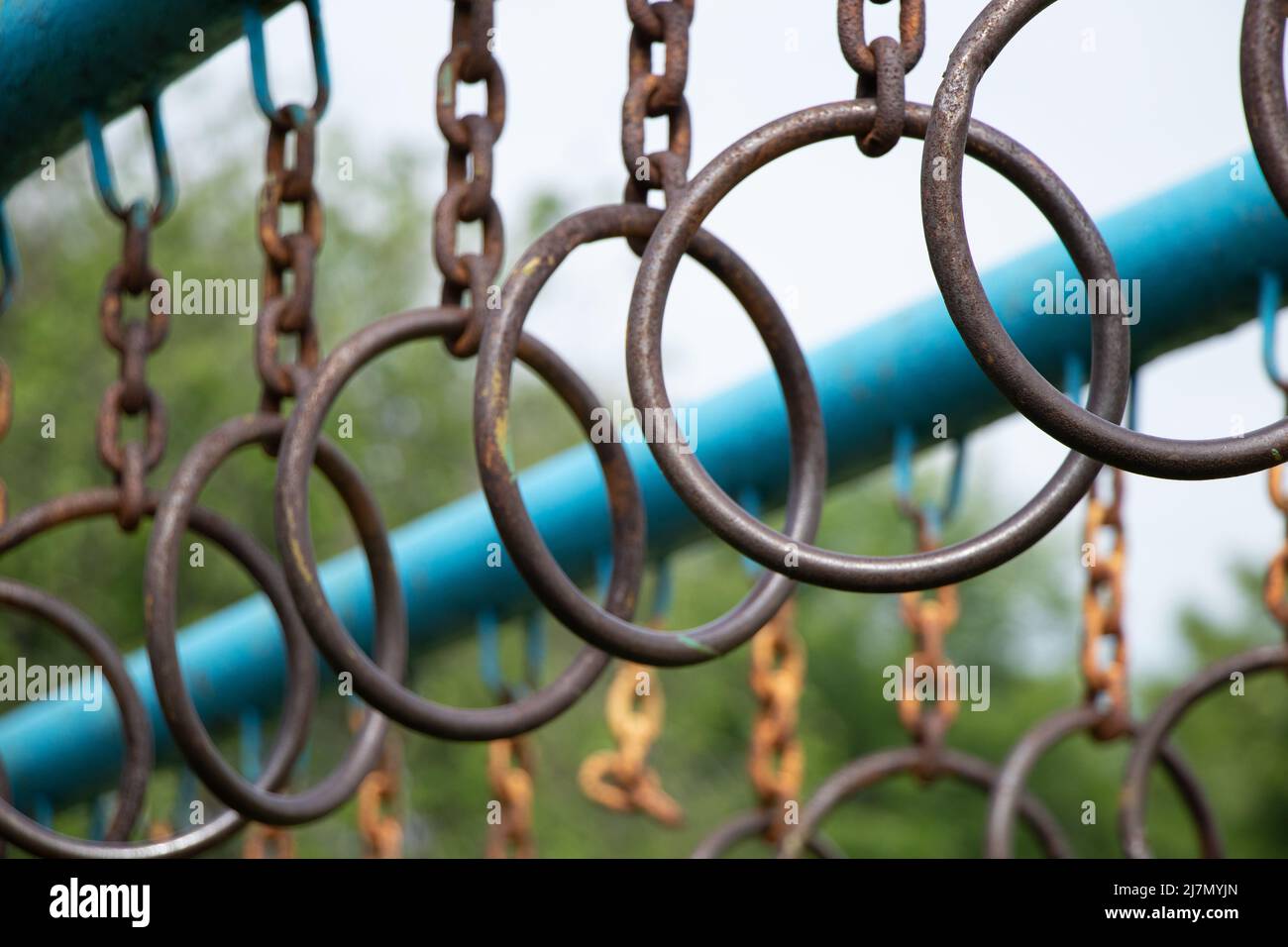 old rusty rings on a chain on a horizontal bar for gymnastics on the ...
