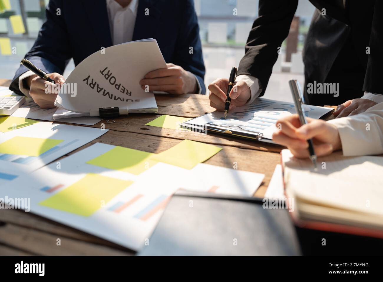 Financial, accounting, investment advisor consulting with her team at ...