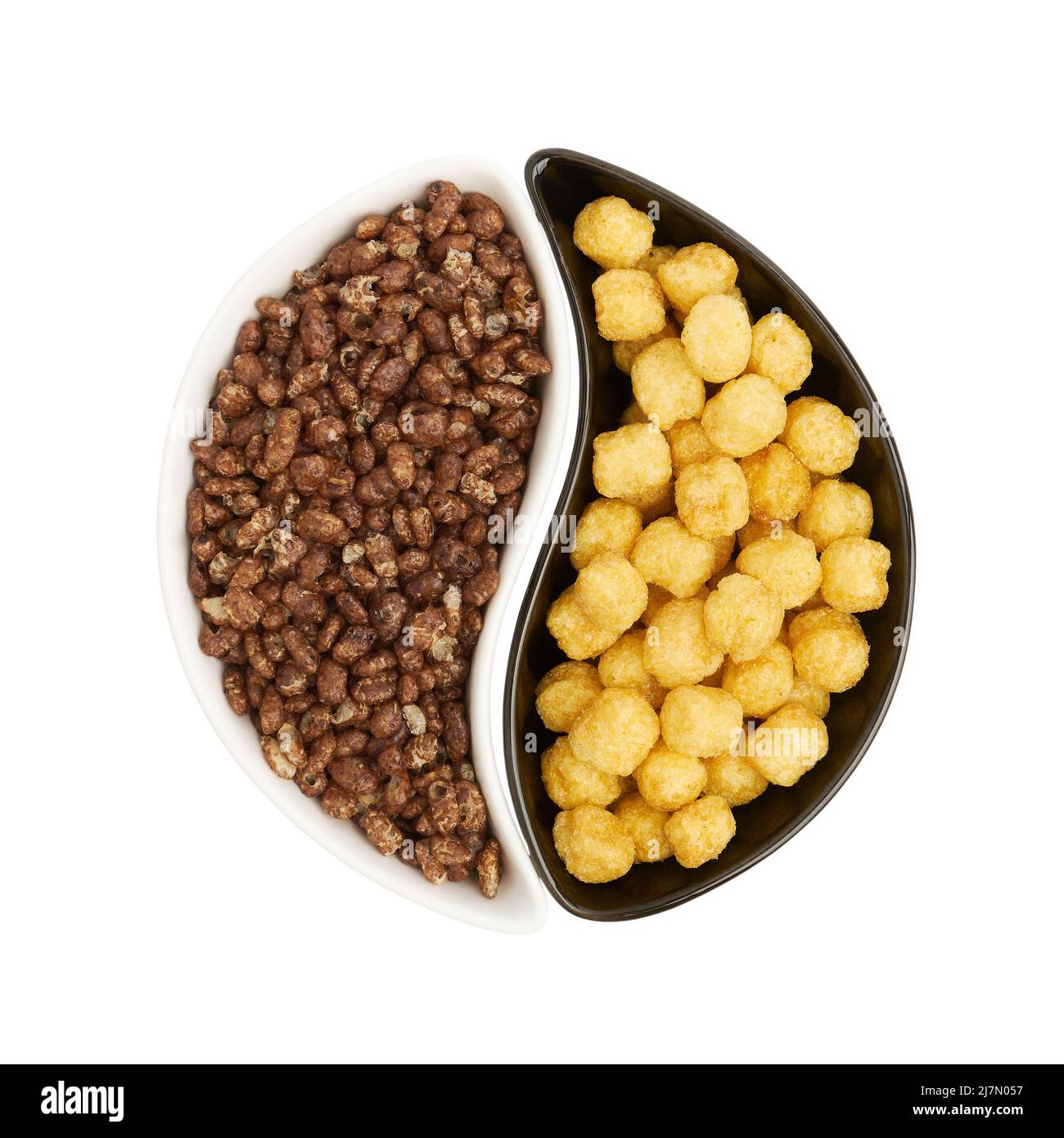 Dried breakfast cereals in Yin-Yang plates isolated on white background ...