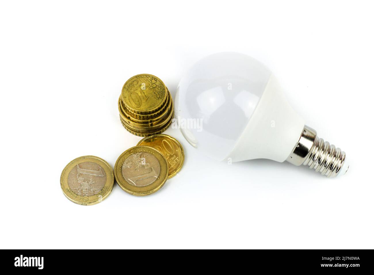 Led light bulb next to euro coins on white background Stock Photo - Alamy