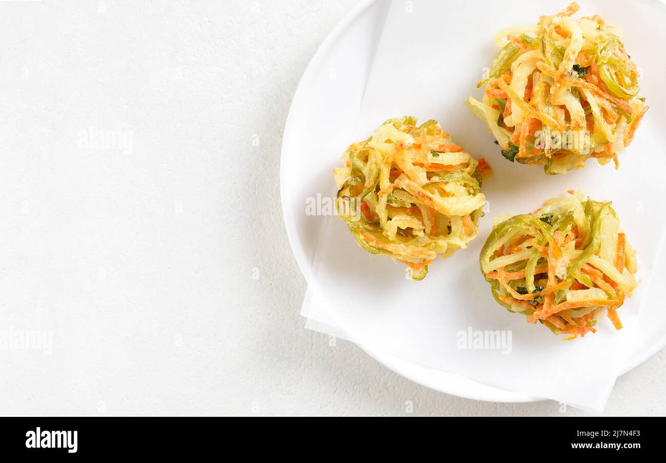 Close up view of japanese kakiage tempura on plate over white ...