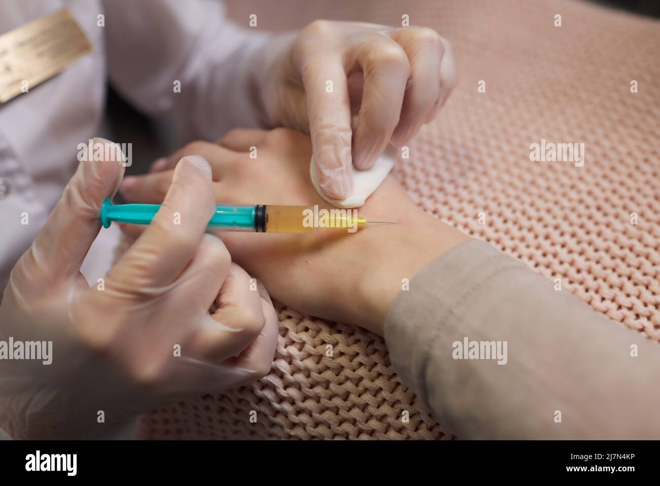 Doctor doing stem cell therapy on a patient's elbow after the injury. Treating knee pain with ...