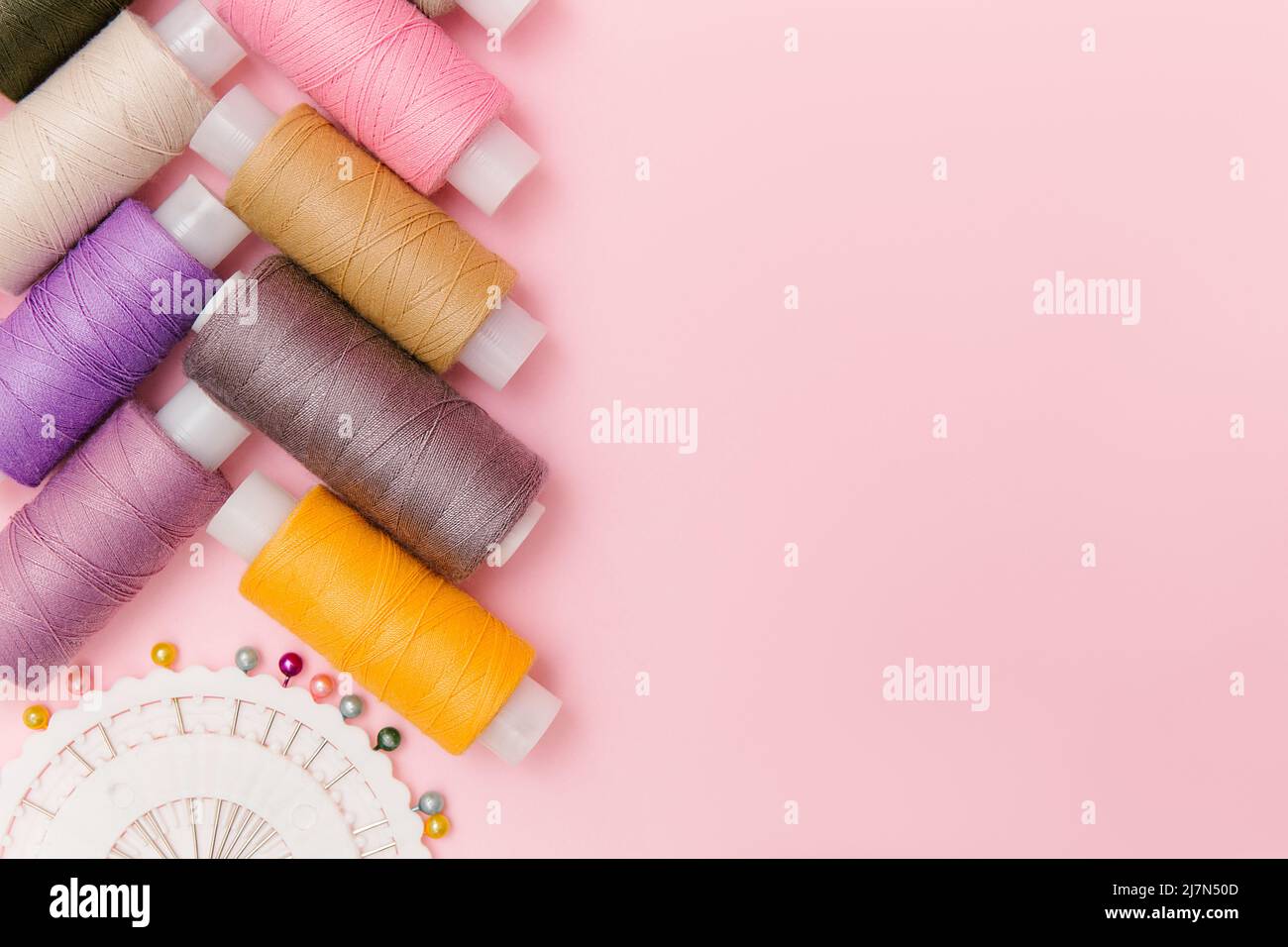 Sewing tools and sewing accessories on elegant pink background ...