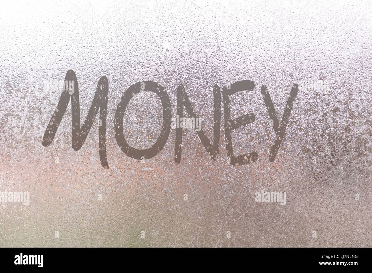 Foggy glass on window with written word money Stock Photo - Alamy