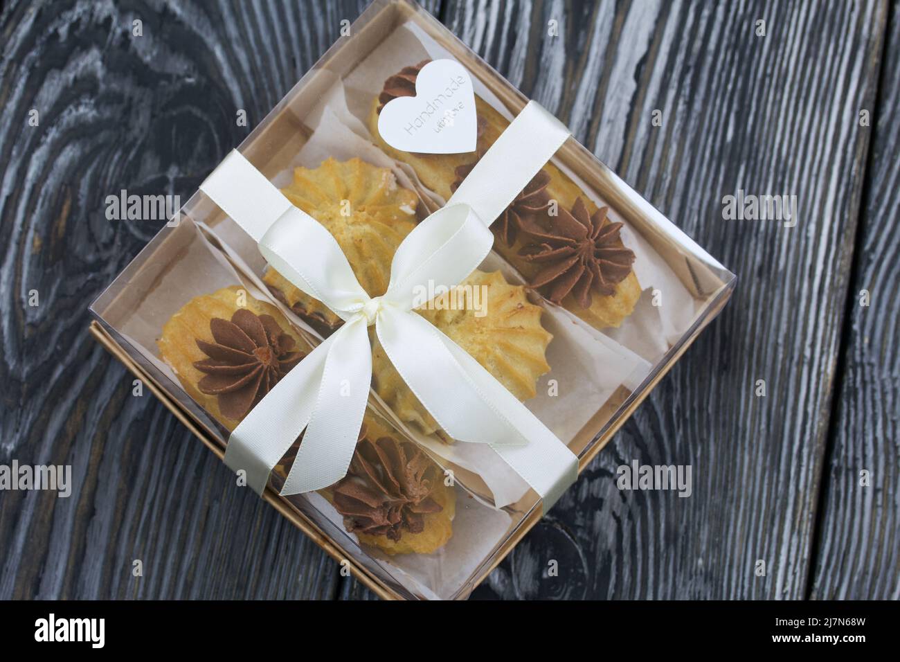 Homemade eclairs with cream. They lie on a plate. Custard pastries with ...