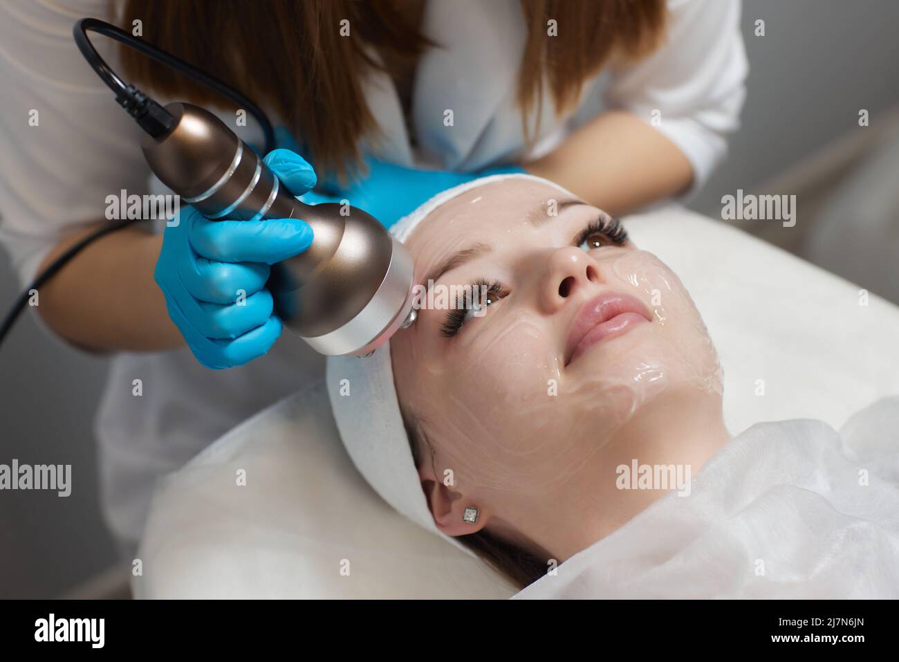 LED light anti-aging mask for facial skin care in a spa slow motion. A ...