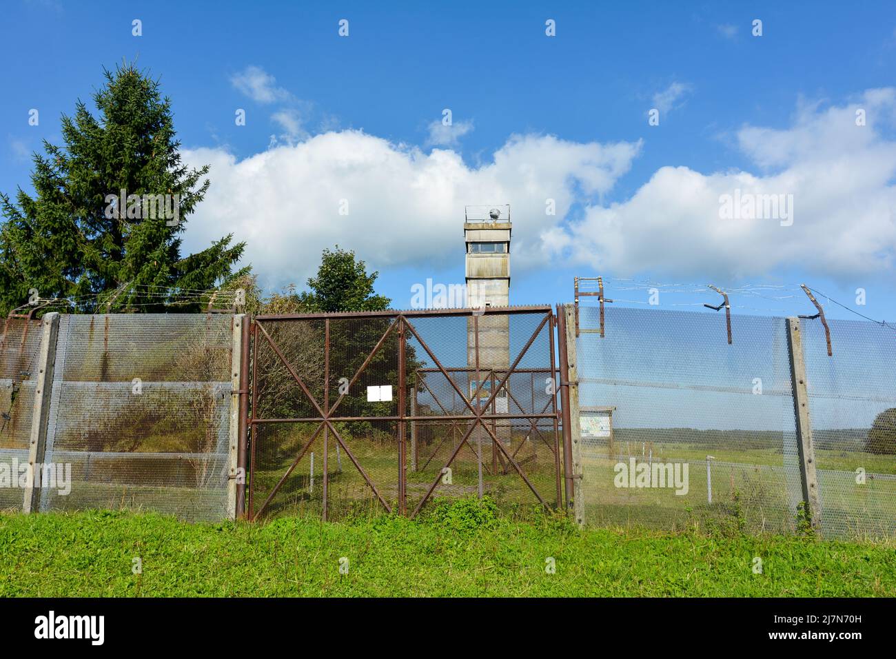 Barbed wire fence and a border watchtower on a former GDR border ...