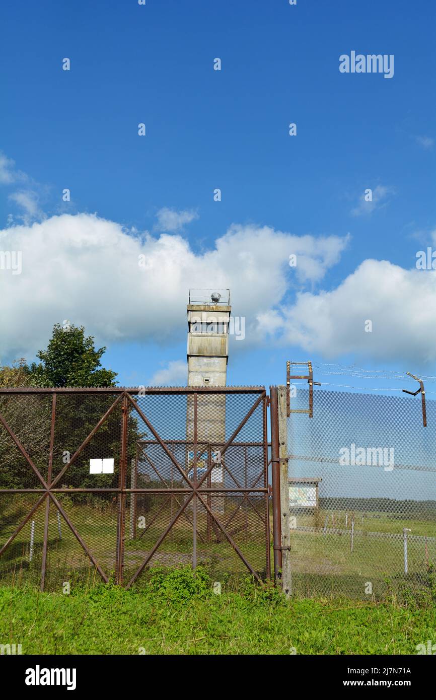 Barbed wire fence and a border watchtower on a former GDR border ...
