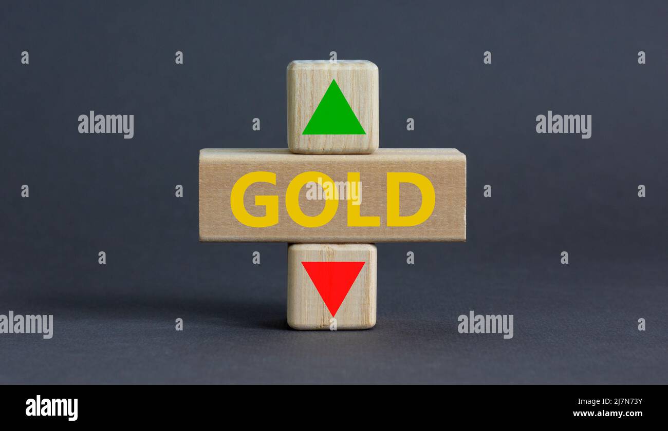 Gold price symbol. A wooden cube with arrow symbolizing that Gold price ...