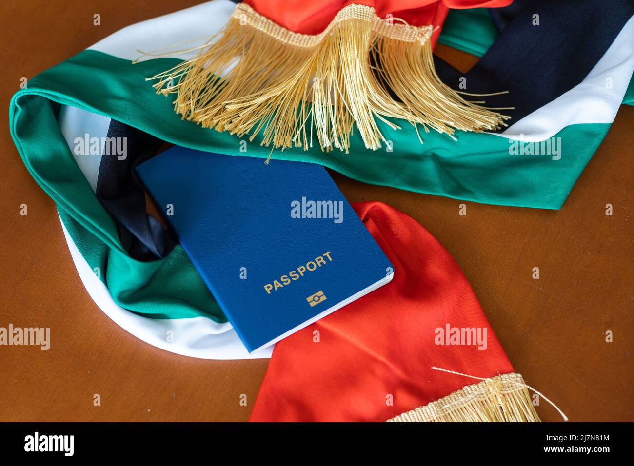 Passport and a United Arab Emirates flag on a wooden background. Travel ...