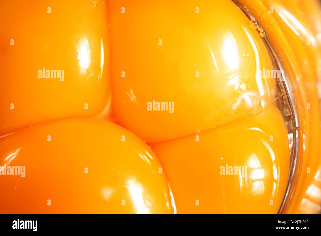 Close-up of egg yolks. Broken eggs and yolks next to each other. Smooth ...