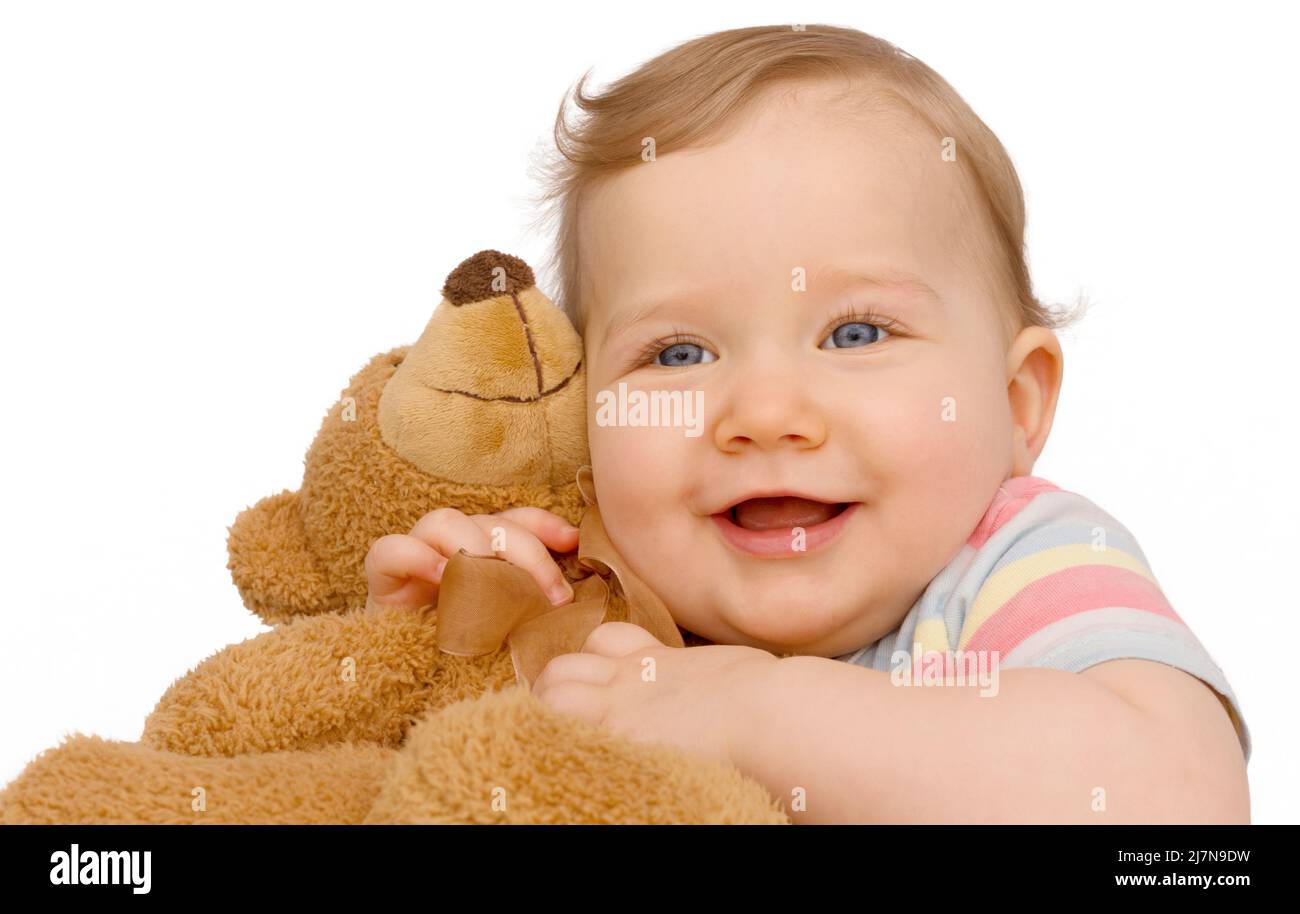 Toddler cuddles the furry teddy bear Stock Photo - Alamy