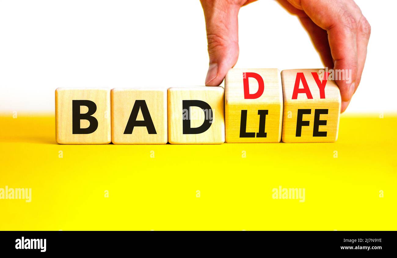 Bad day or life symbol. Businessman turns wooden cubes and changes ...