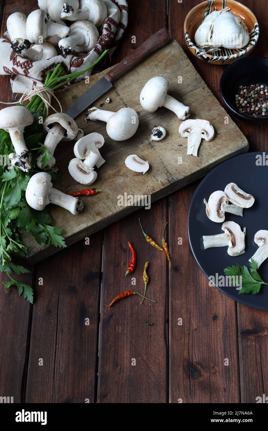 Fresh champignon mushrooms and ingredients for cooking on rustic ...