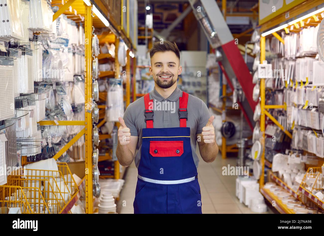 Happy salesman at DIY store guarantees best quality of goods, smiles ...