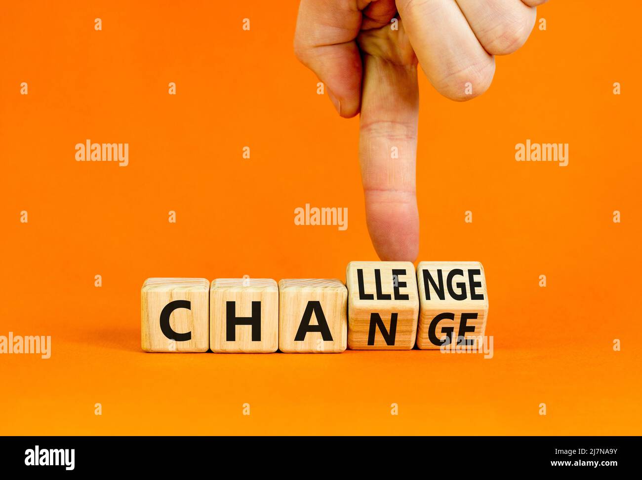 Chance or challenge symbol. Businessman turns wooden cubes and changes ...
