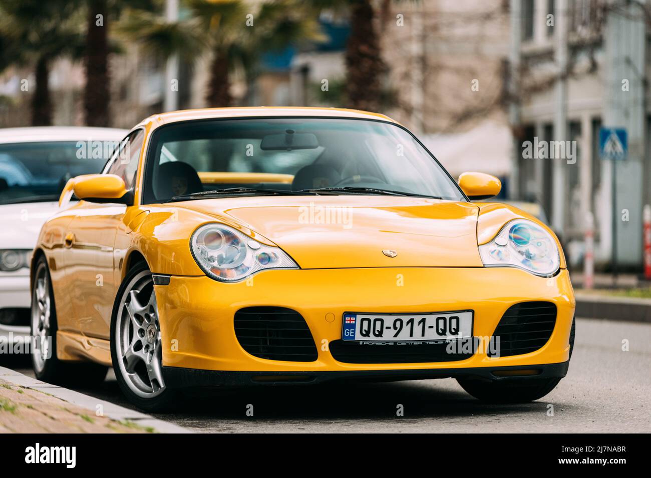 Yellow Porsche 996 Carrera car parked on street. Porsche Sports car S ...