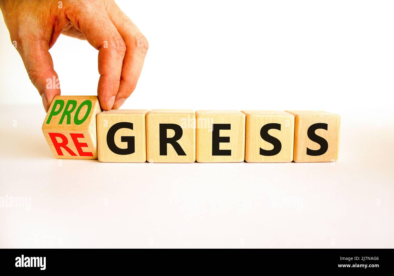 Regress or progress symbol. Businessman turns wooden cubes and changes ...