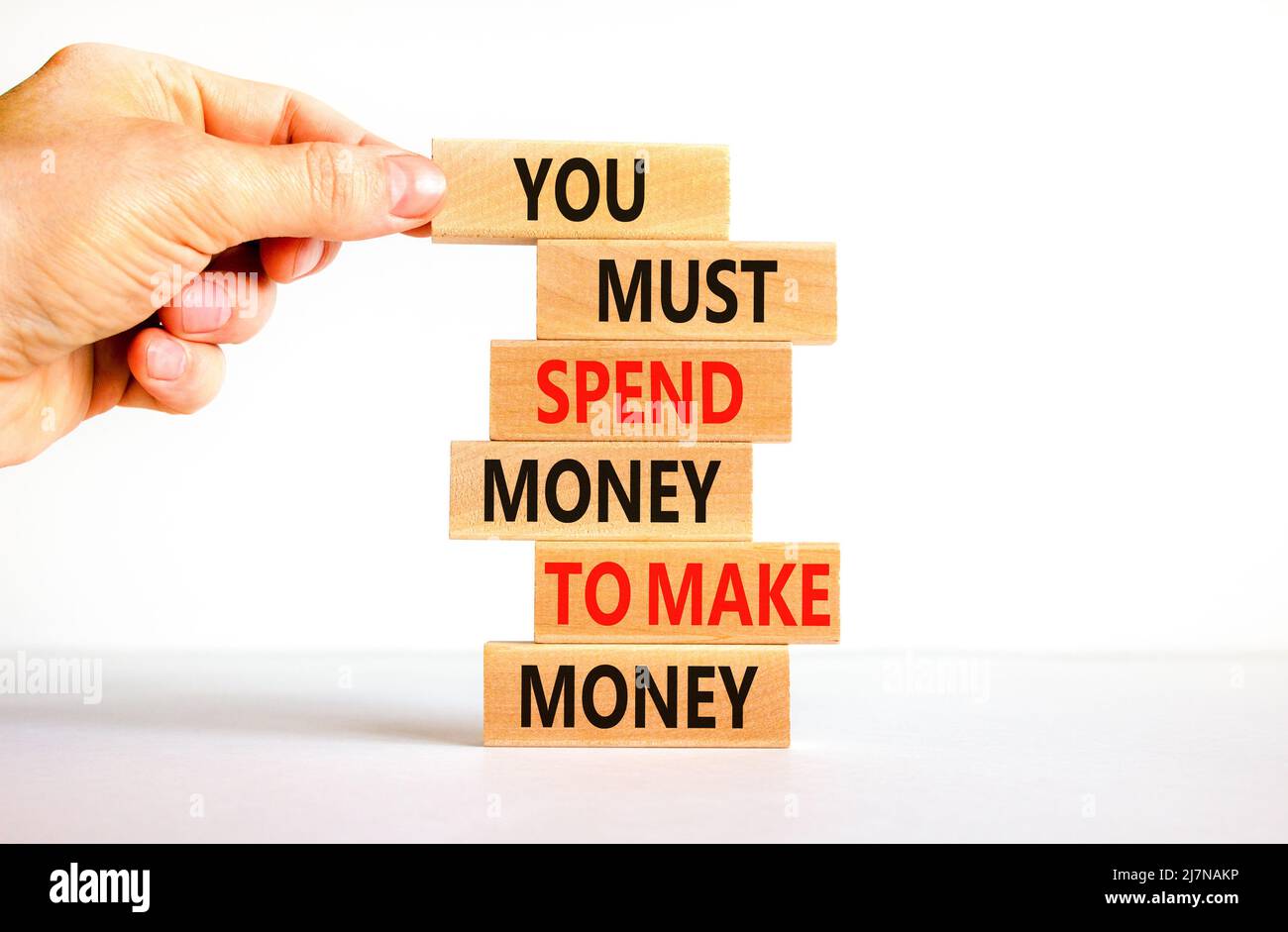 Spend and make money symbol. Wood blocks with words You must spend ...