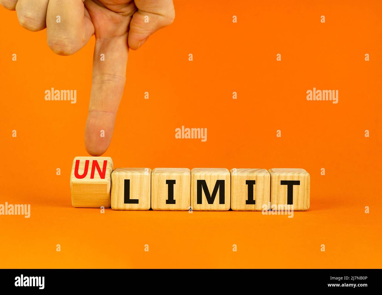 Limit or unlimit symbol. Businessman turns wooden cubes and changes the ...