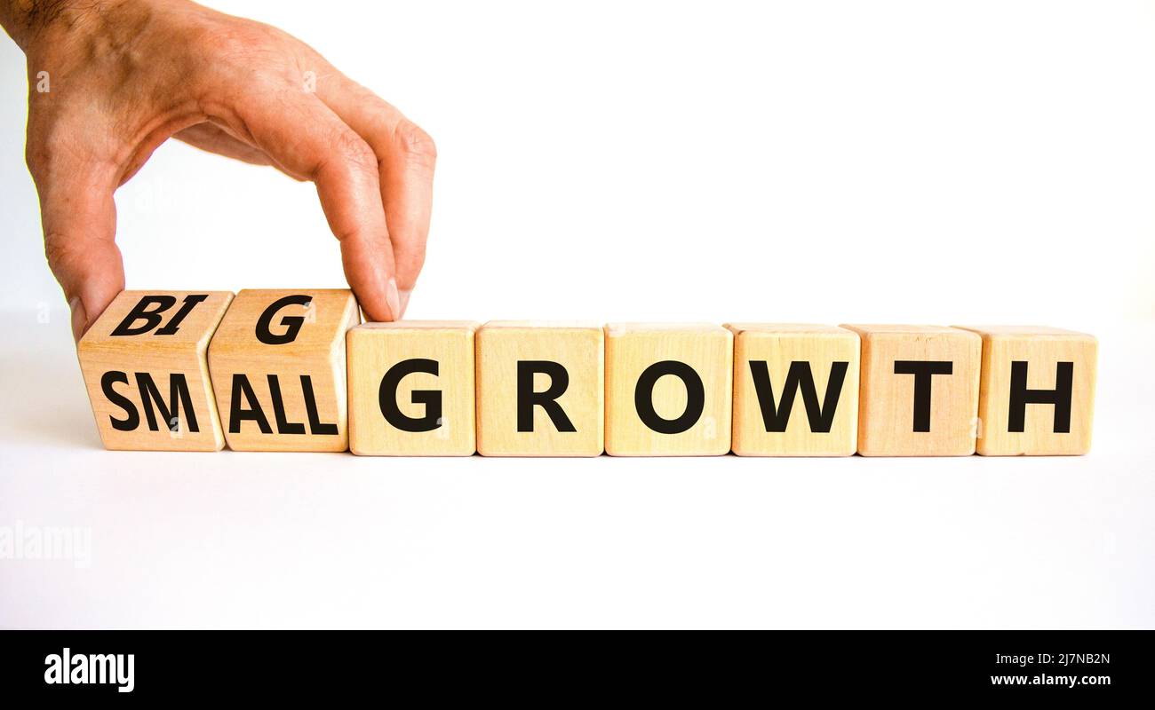 Big or small growth symbol. Businessman turns wooden cubes and changes ...
