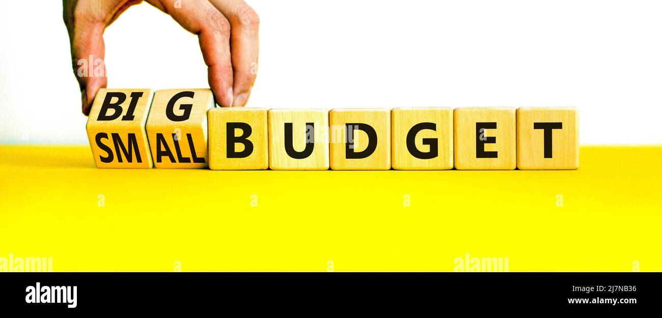 Big or small budget symbol. Businessman turns wooden cubes and changes ...