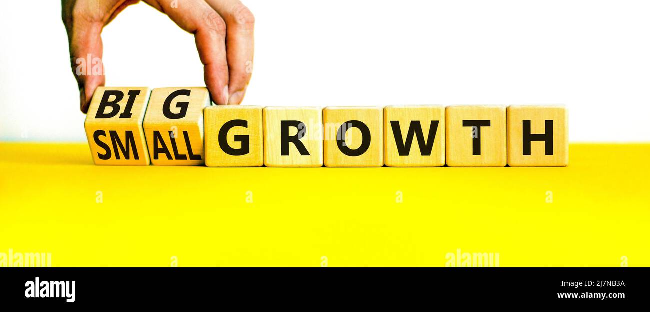 Big or small growth symbol. Businessman turns wooden cubes and changes ...