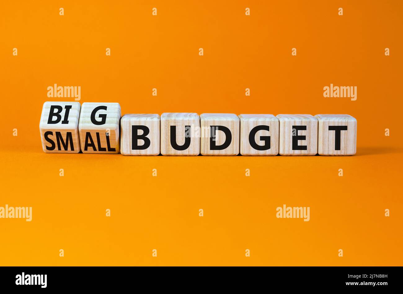 Big or small budget symbol. Turned wooden cubes and changed concept ...