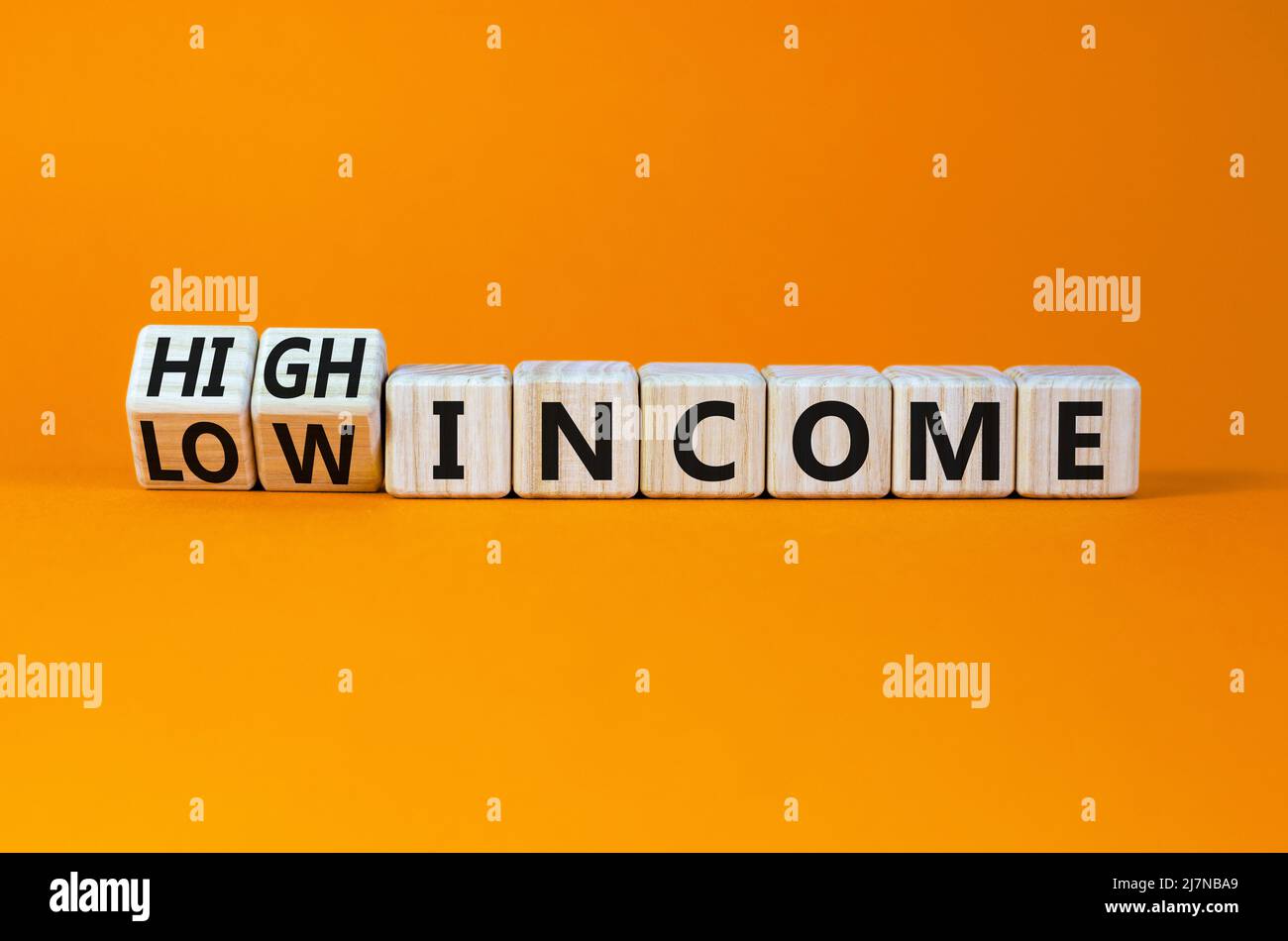 Low or high income symbol. Turned wooden cubes and changed concept ...