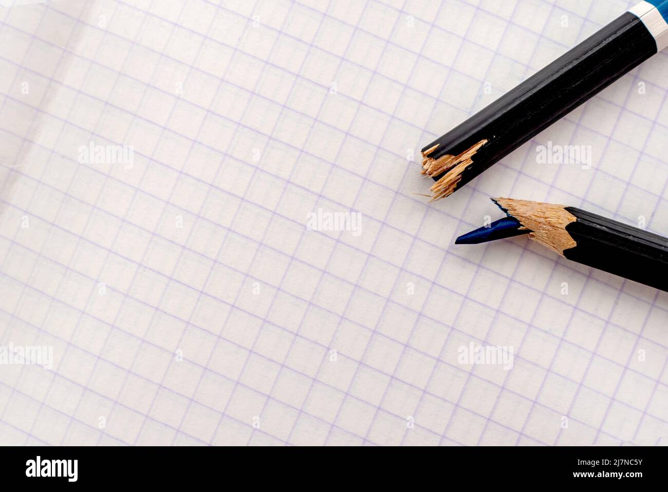 Broken pencil on white checkered paper close-up. cracked pencil Stock ...
