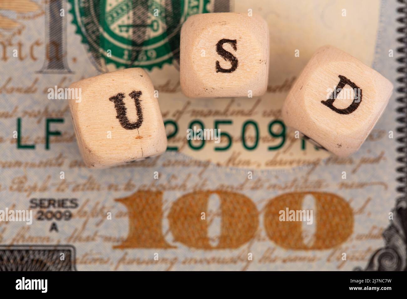 USD word written on wooden blocks on 100 dollar banknote background for ...